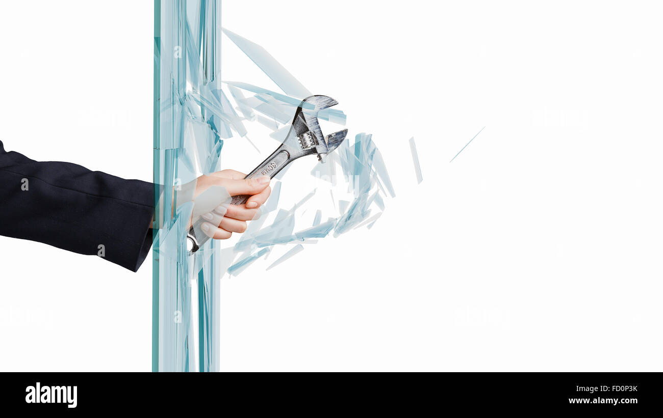 Close up of male hand breaking glass with wrench Stock Photo - Alamy