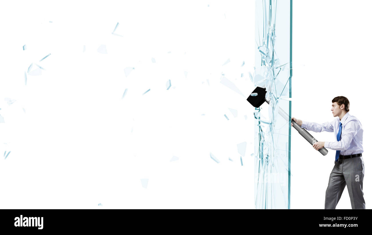 Young determined businessman breaking glass with hammer Stock Photo - Alamy