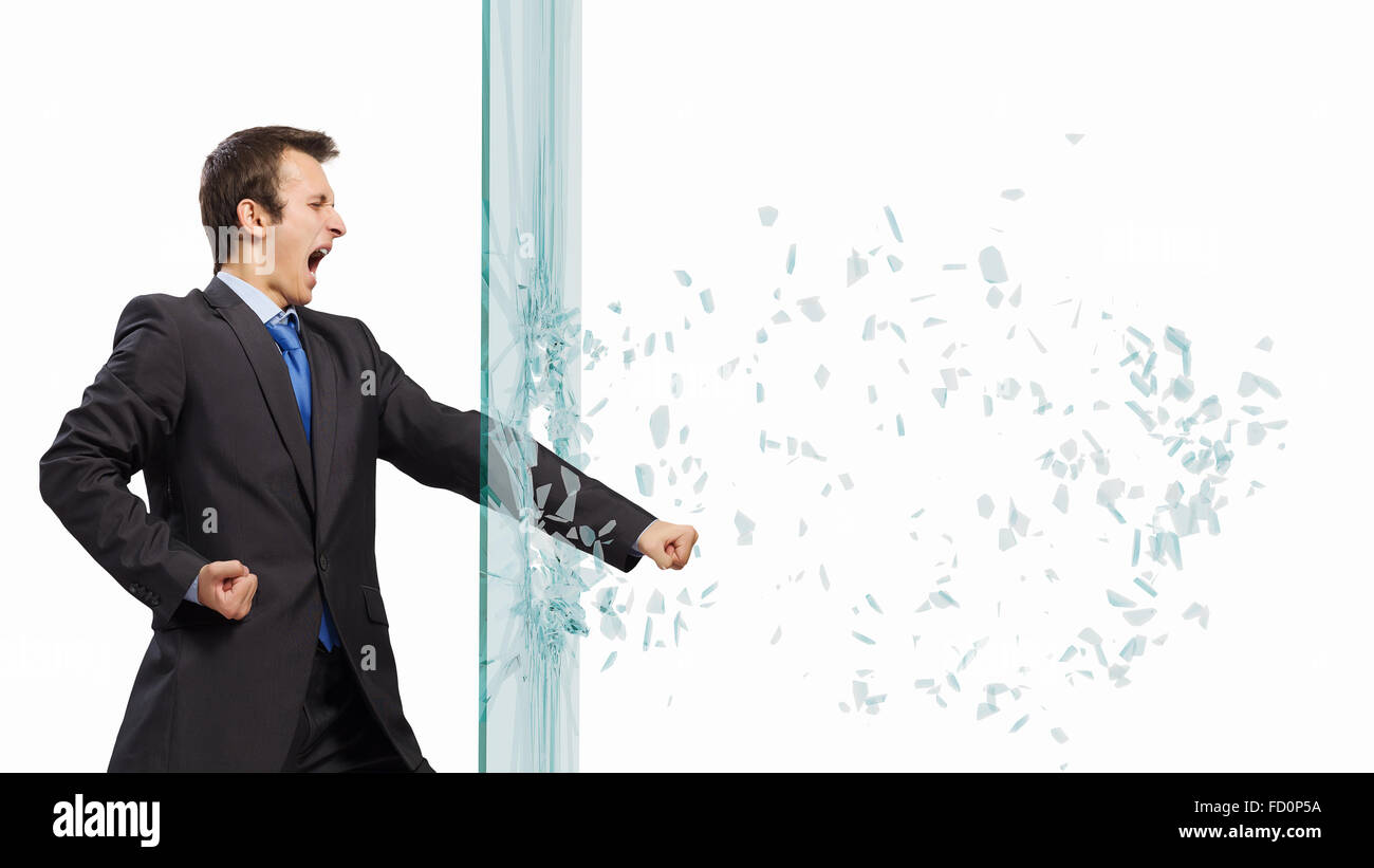 Young determined businessman breaking glass with karate punch Stock ...
