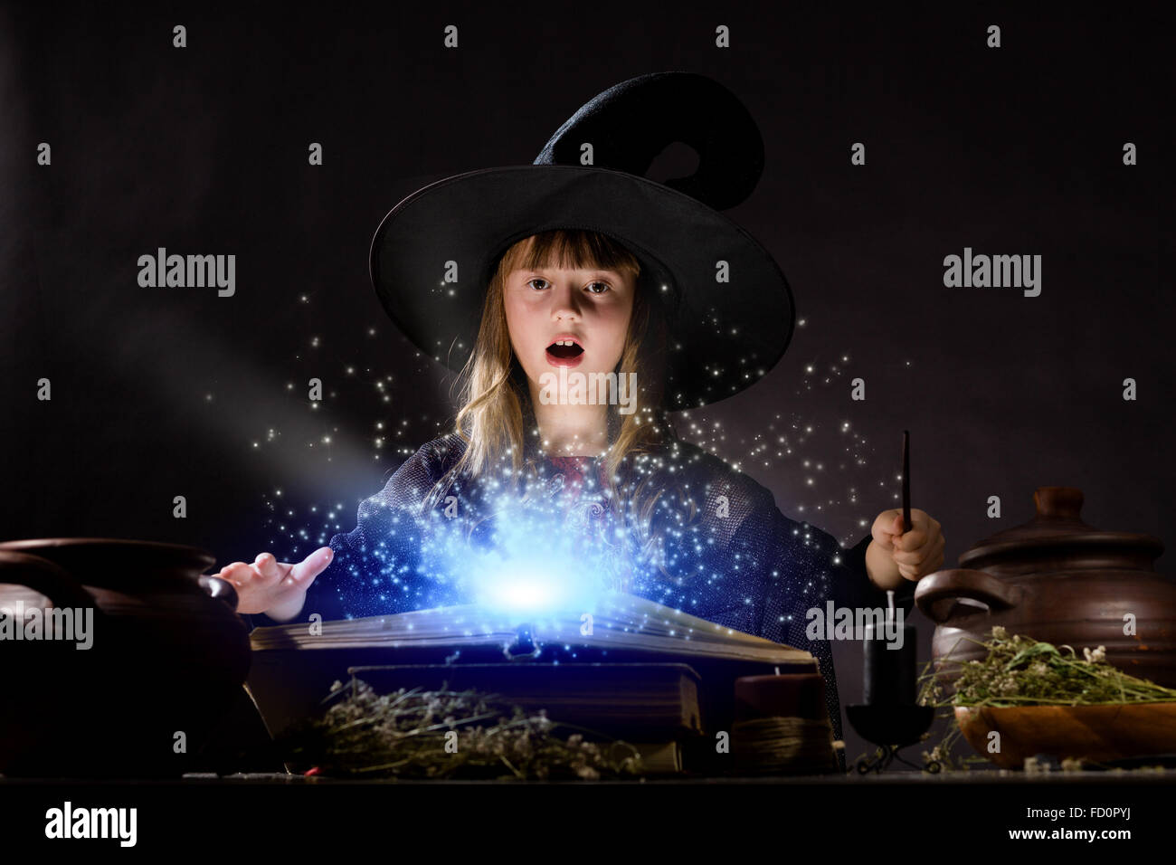 Little Halloween witch making magic with stick Stock Photo - Alamy Little Halloween witch making magic with stick Stock Photo - Alamy