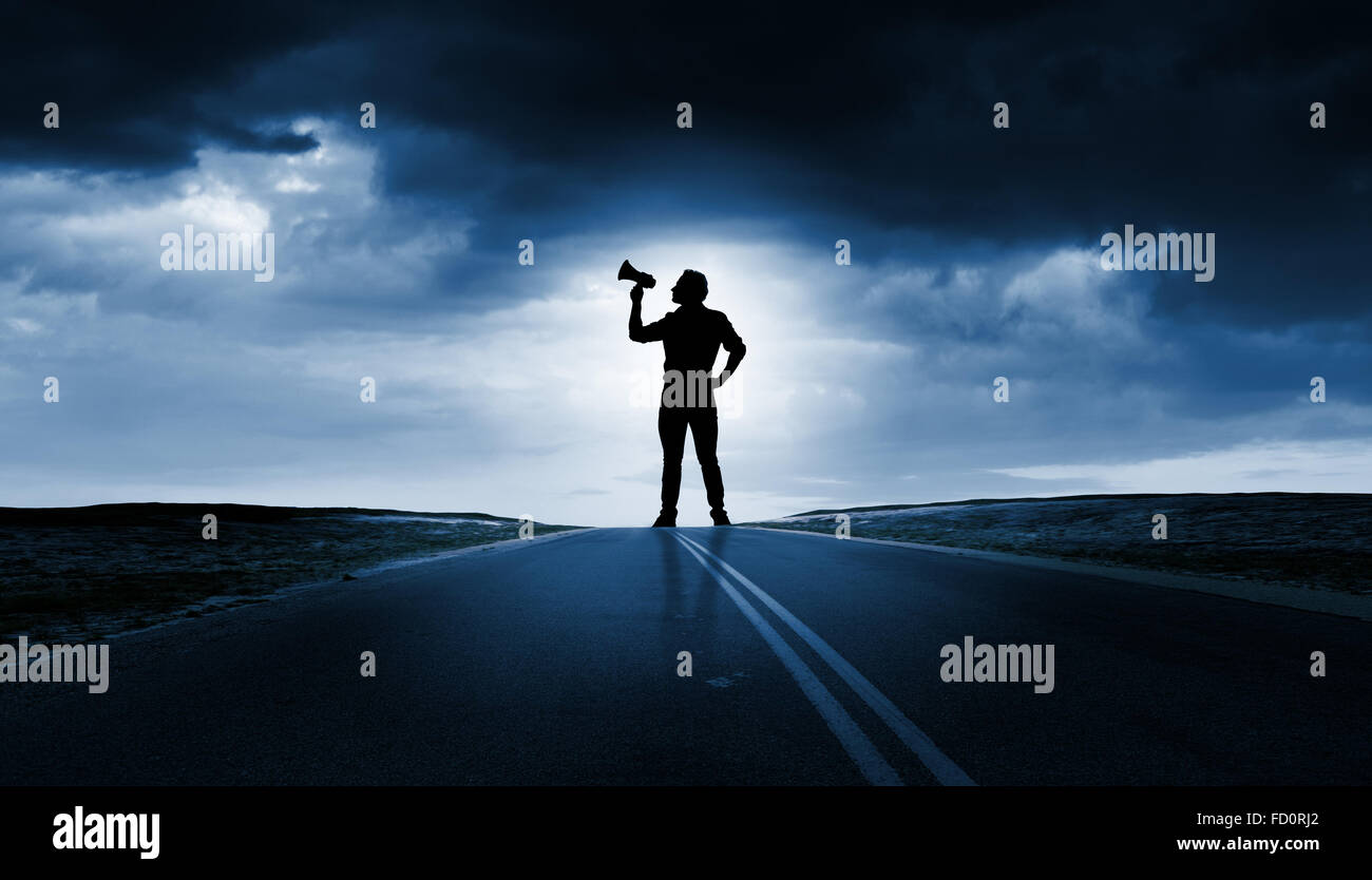 Silhouette of man screaming in trumpet at night Stock Photo - Alamy