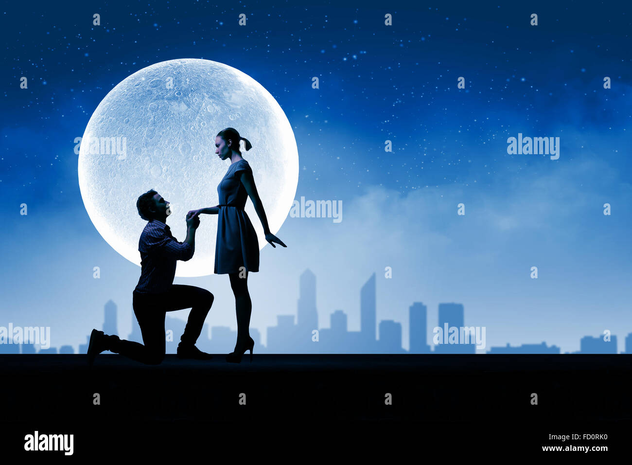 Silhouettes of man making proposal to woman Stock Photo - Alamy