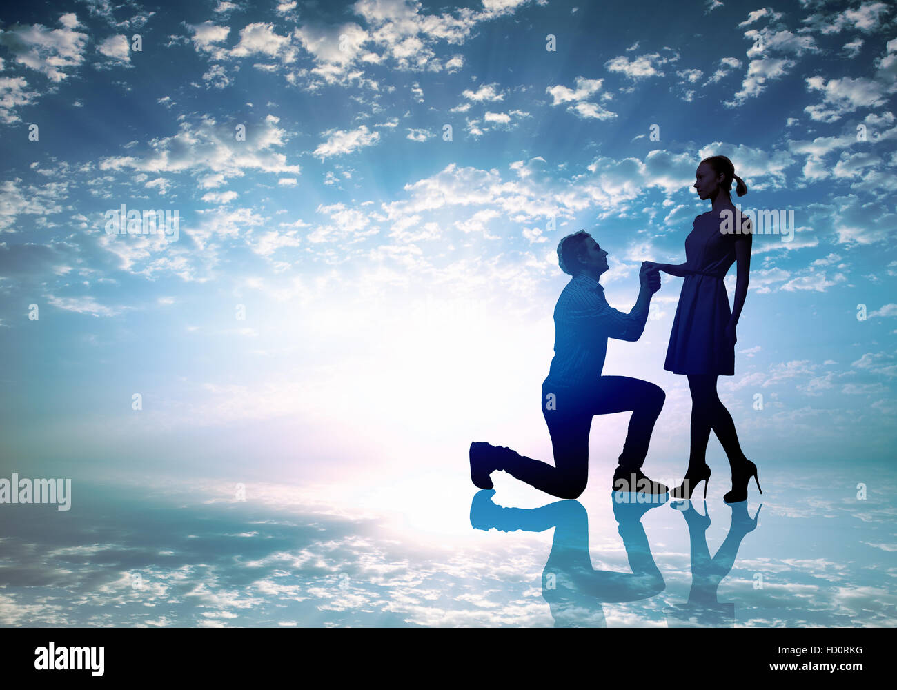 Silhouettes of man making proposal to woman Stock Photo - Alamy