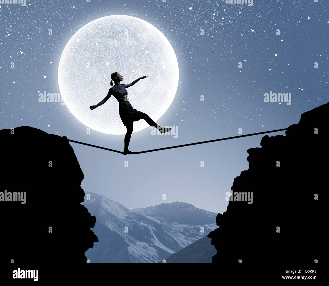 Silhouette of woman balancing on rope above gap Stock Photo - Alamy