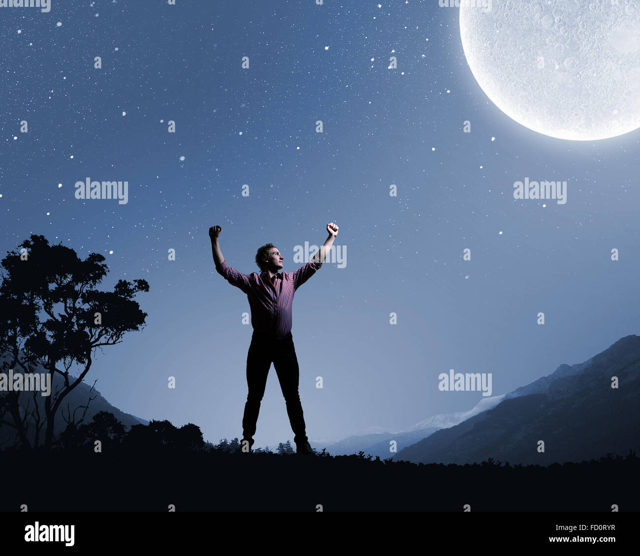 Young man at night with big full moon at background Stock Photo - Alamy