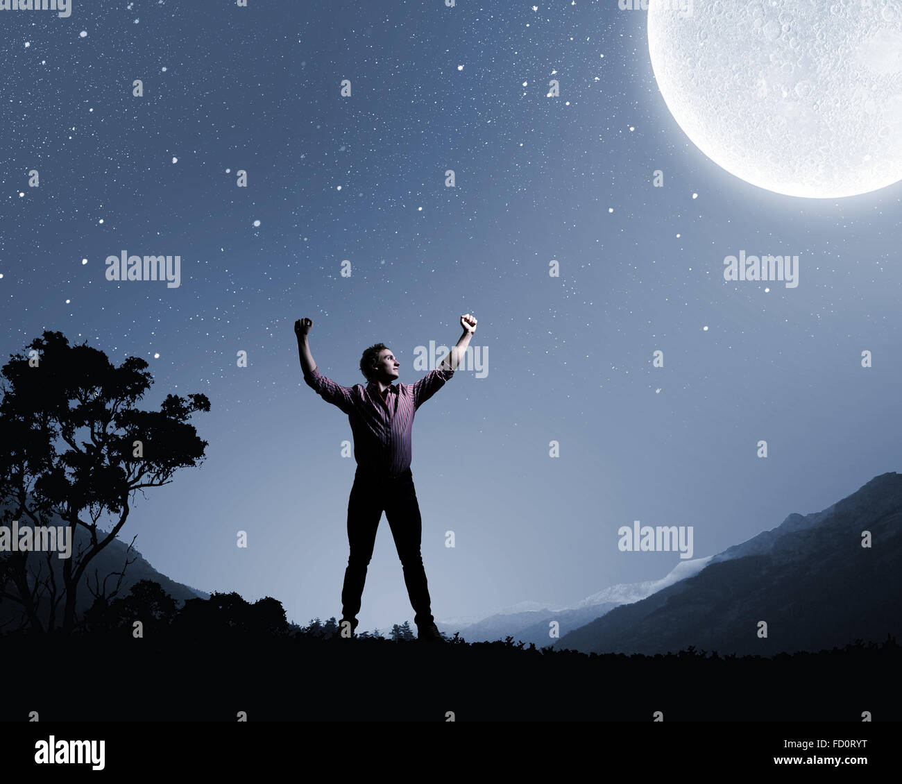 Young man at night with big full moon at background Stock Photo - Alamy