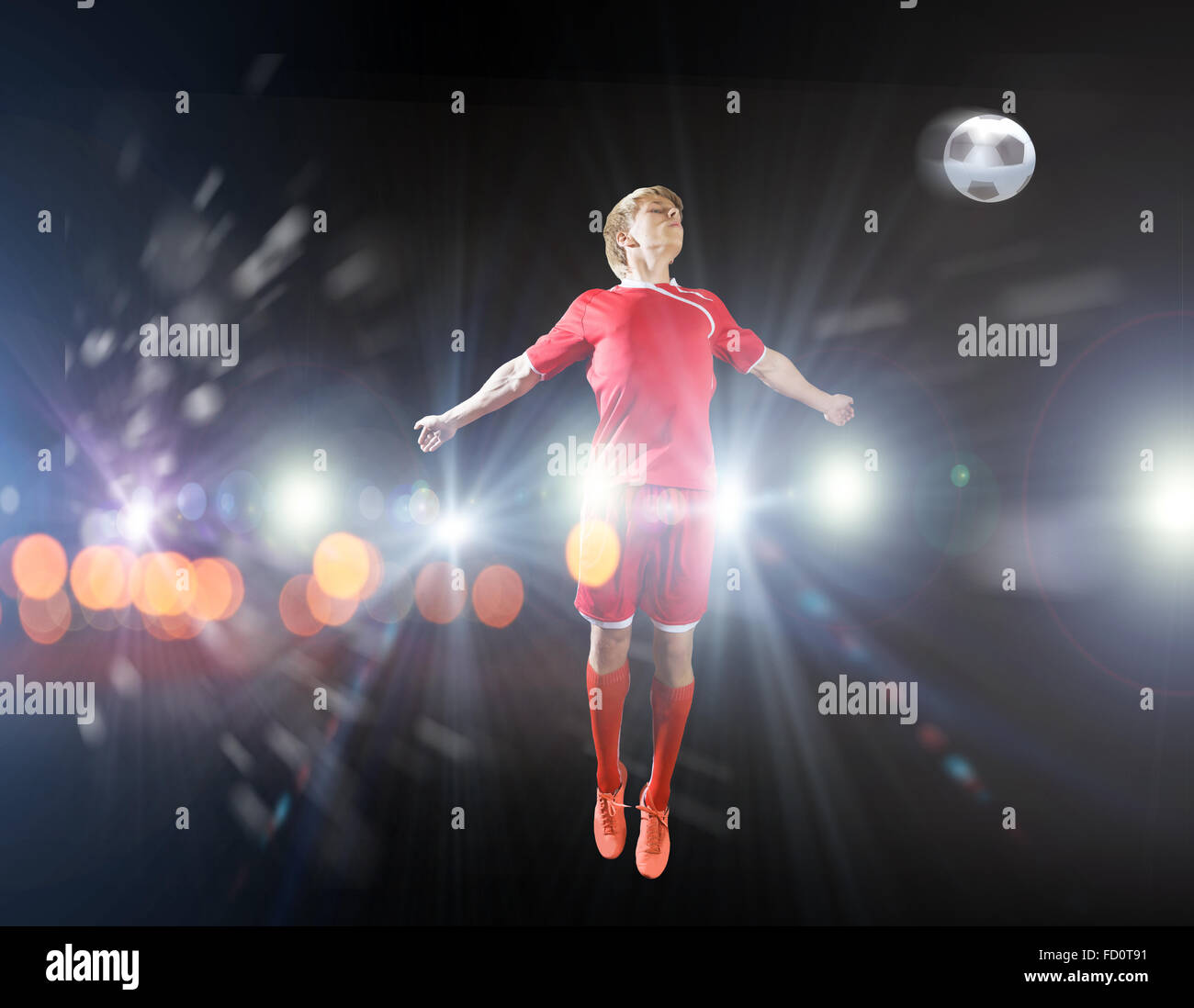 Young football player on stadium kicking ball in jump hi-res stock ...