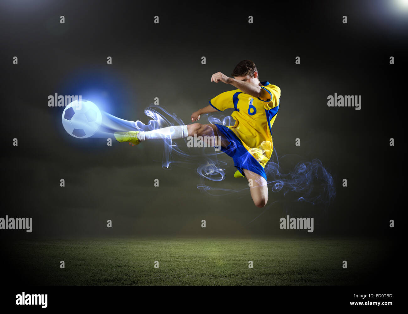 Young football player on stadium in jump taking ball Stock Photo - Alamy