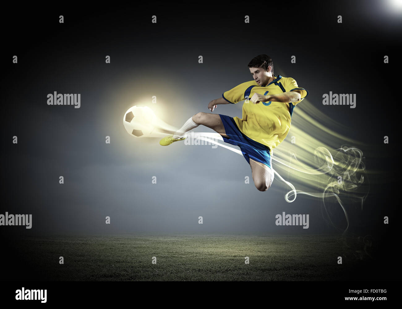 Young football player on stadium in jump taking ball Stock Photo - Alamy