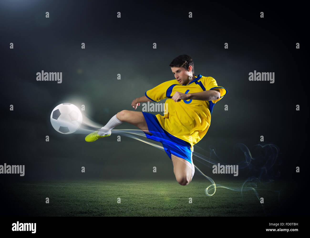 Young football player on stadium in jump taking ball Stock Photo - Alamy