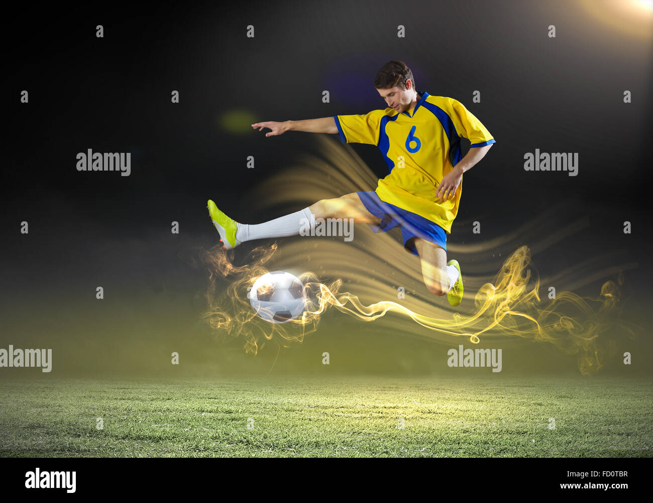 Young football player on stadium in jump taking ball Stock Photo - Alamy