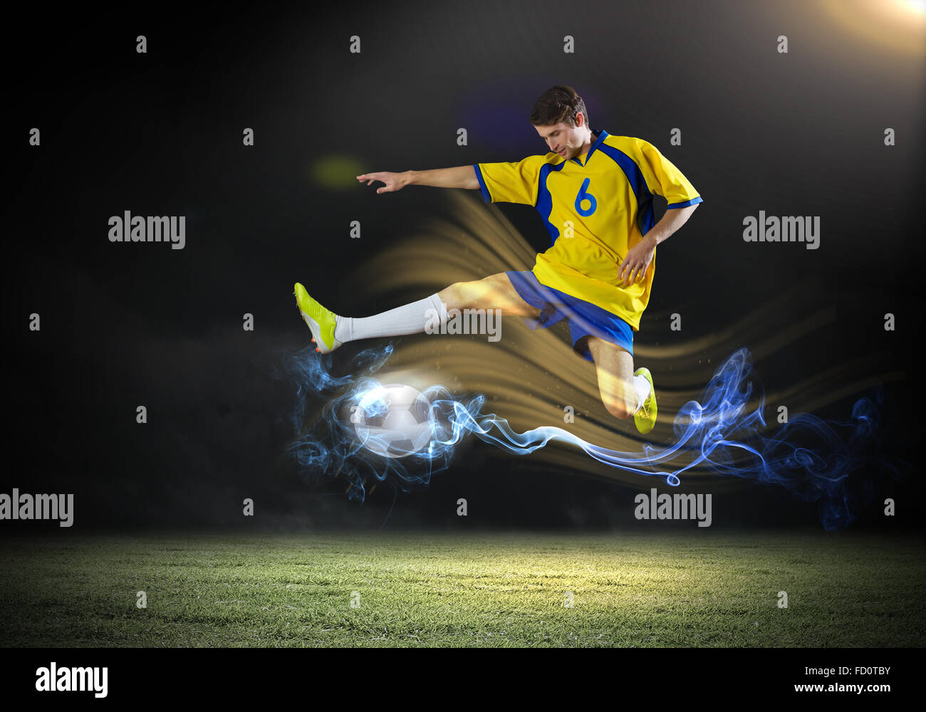 Young football player on stadium in jump taking ball Stock Photo - Alamy