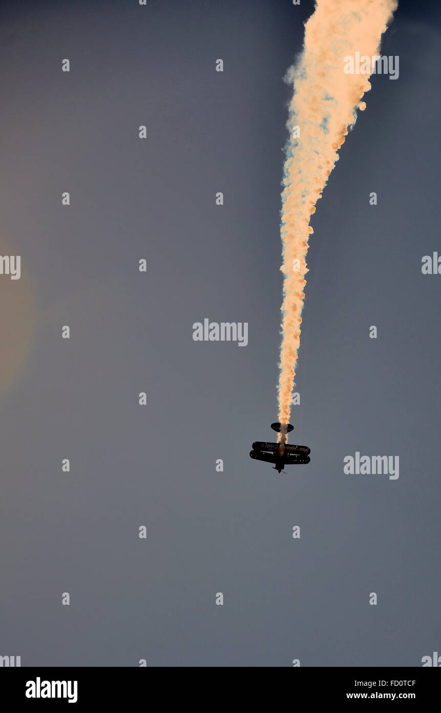 Acrobatic plane doing stunts and dropping smoke Stock Photo - Alamy