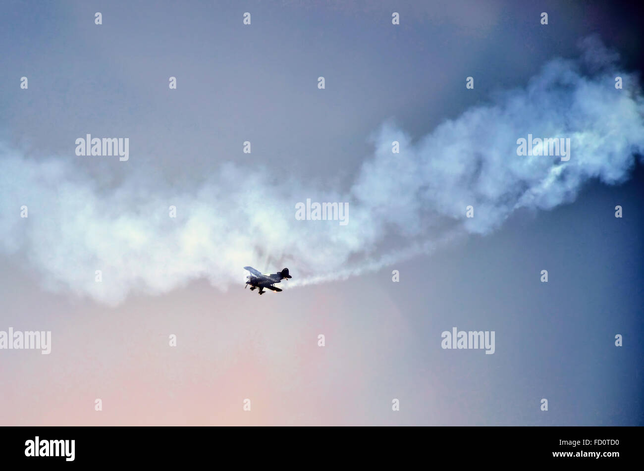 Acrobatic plane doing stunts and dropping smoke Stock Photo - Alamy