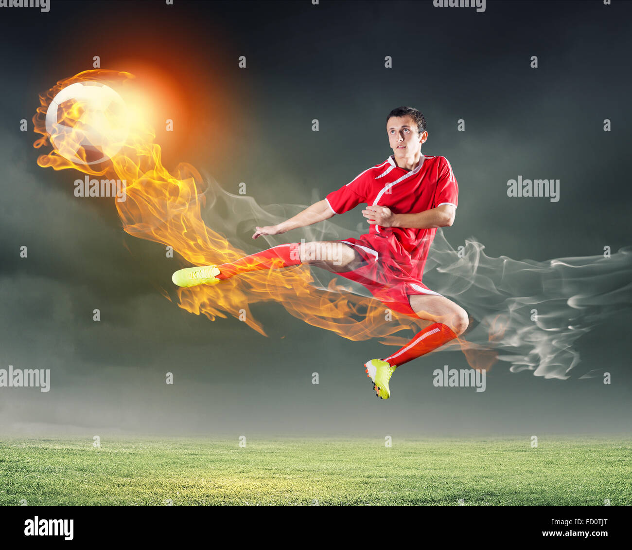 Young football player on stadium in jump taking ball Stock Photo - Alamy