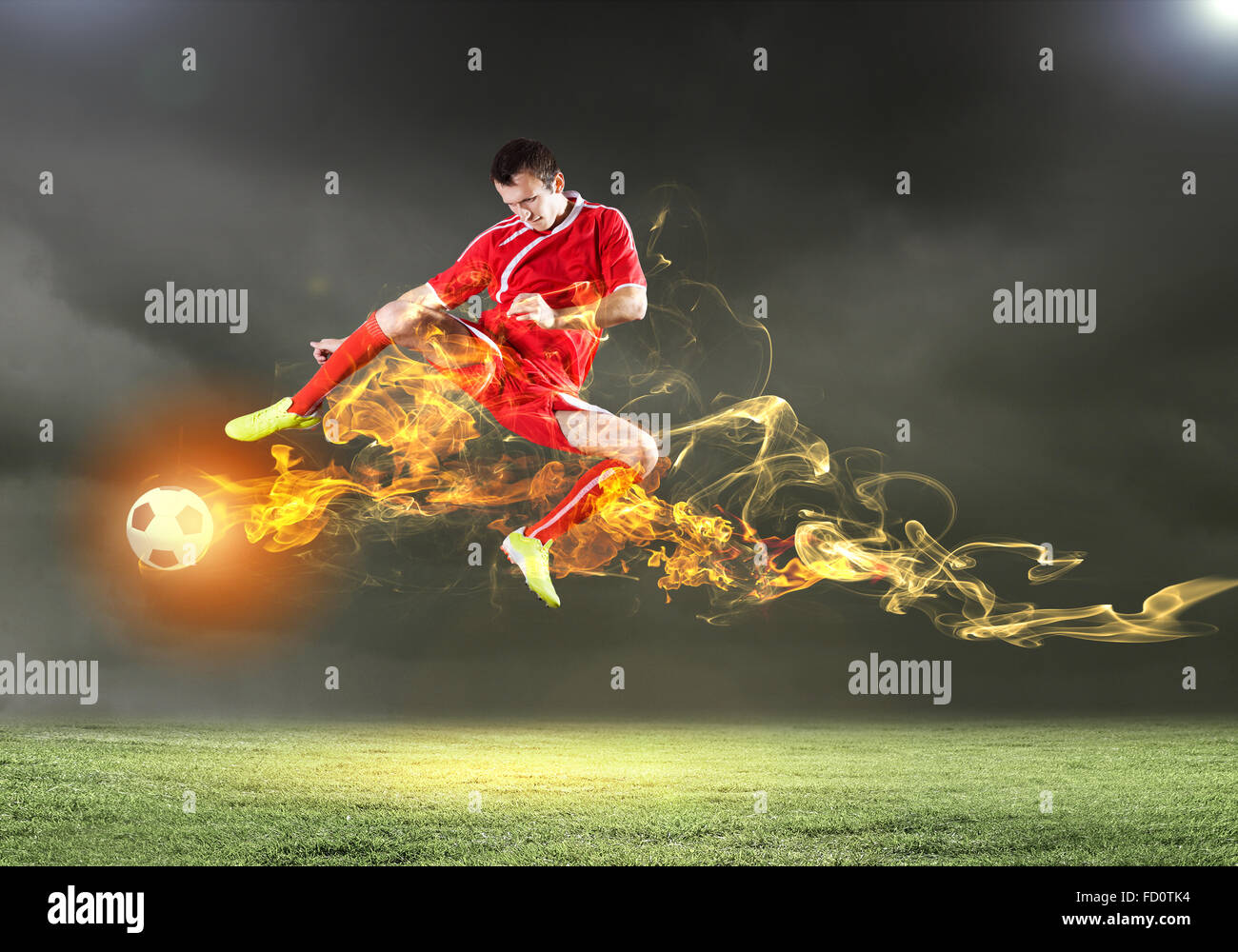 Young football player on stadium in jump taking ball Stock Photo - Alamy