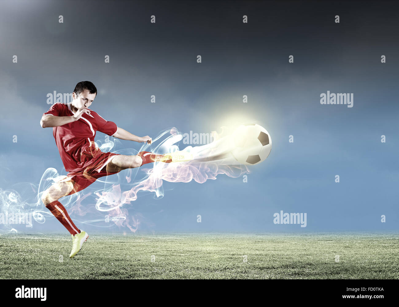 Young football player on stadium in jump taking ball Stock Photo - Alamy