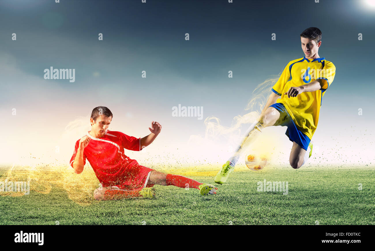 Two young football players struggling for ball Stock Photo - Alamy