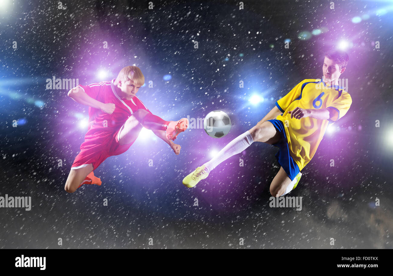 Two young football players struggling for ball Stock Photo - Alamy