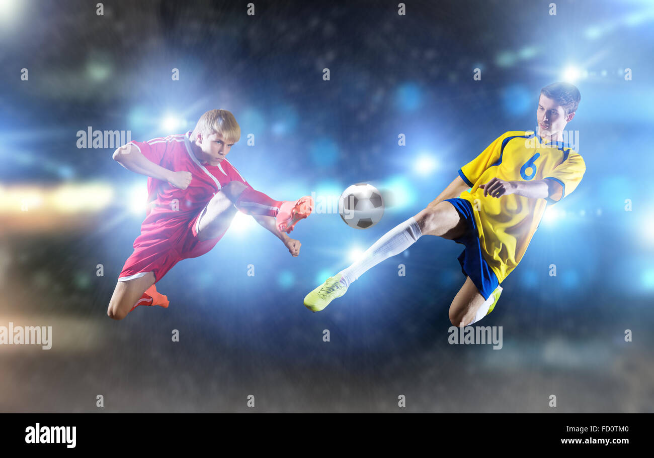 Two young football players struggling for ball Stock Photo - Alamy