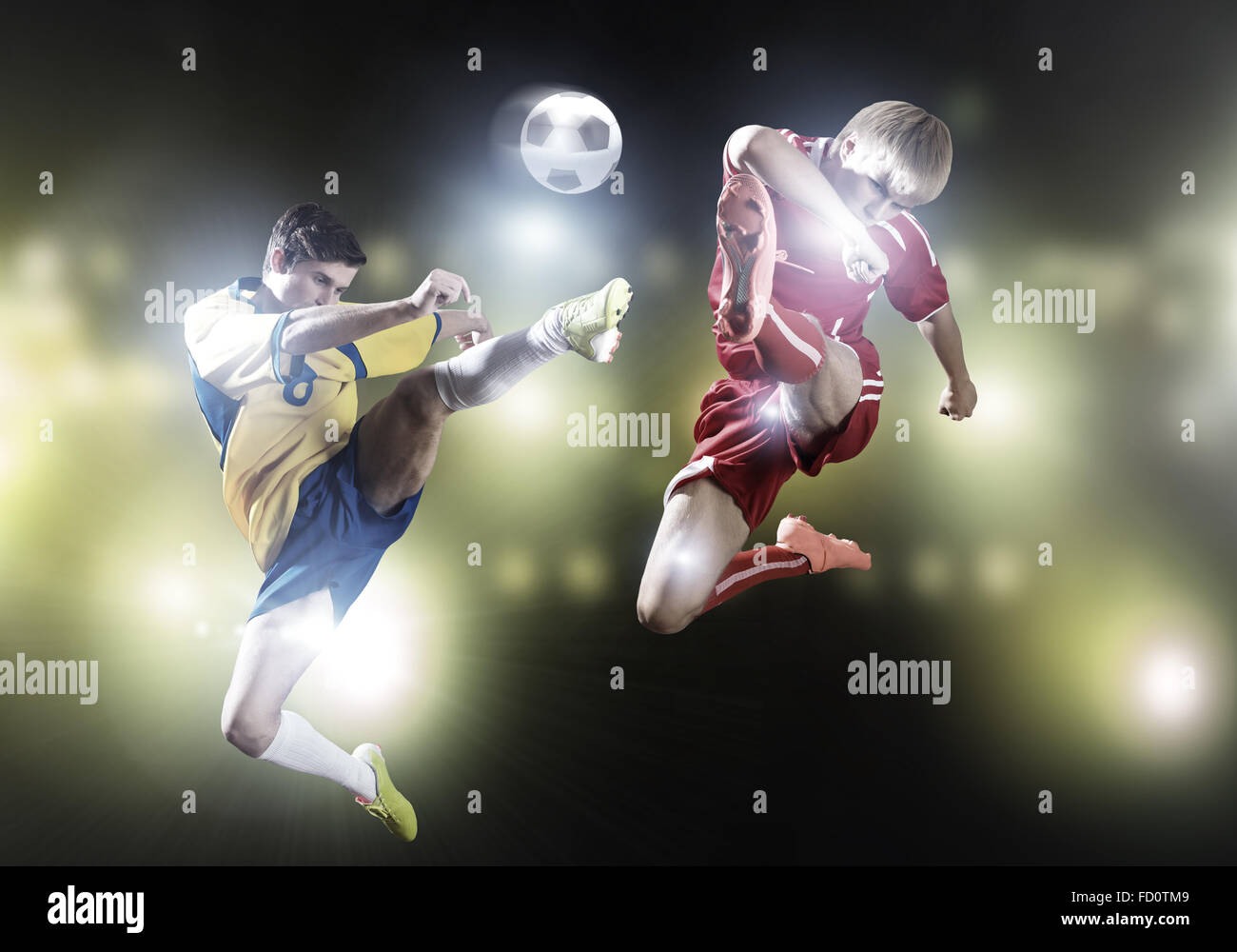 Two young football players struggling for ball Stock Photo - Alamy