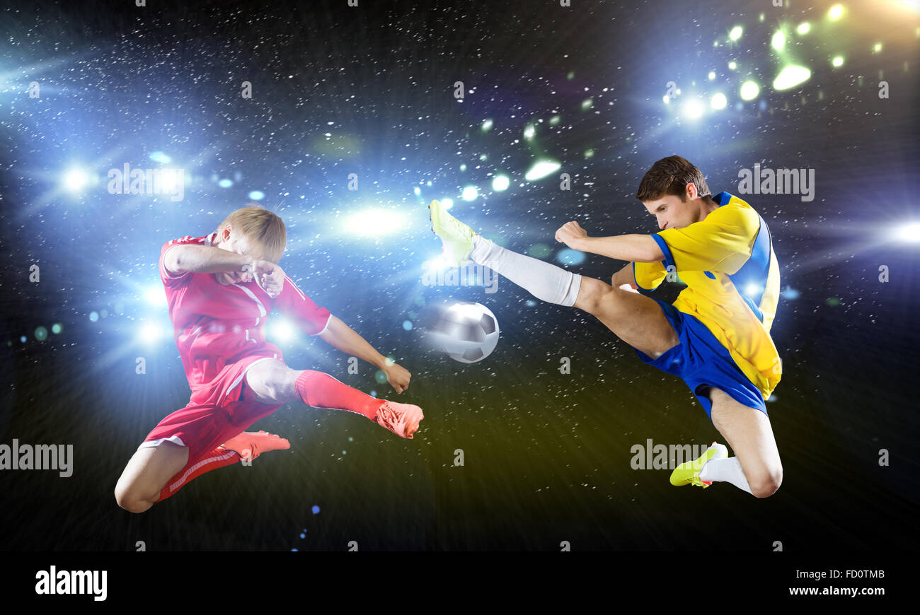 Two young football players struggling for ball Stock Photo - Alamy