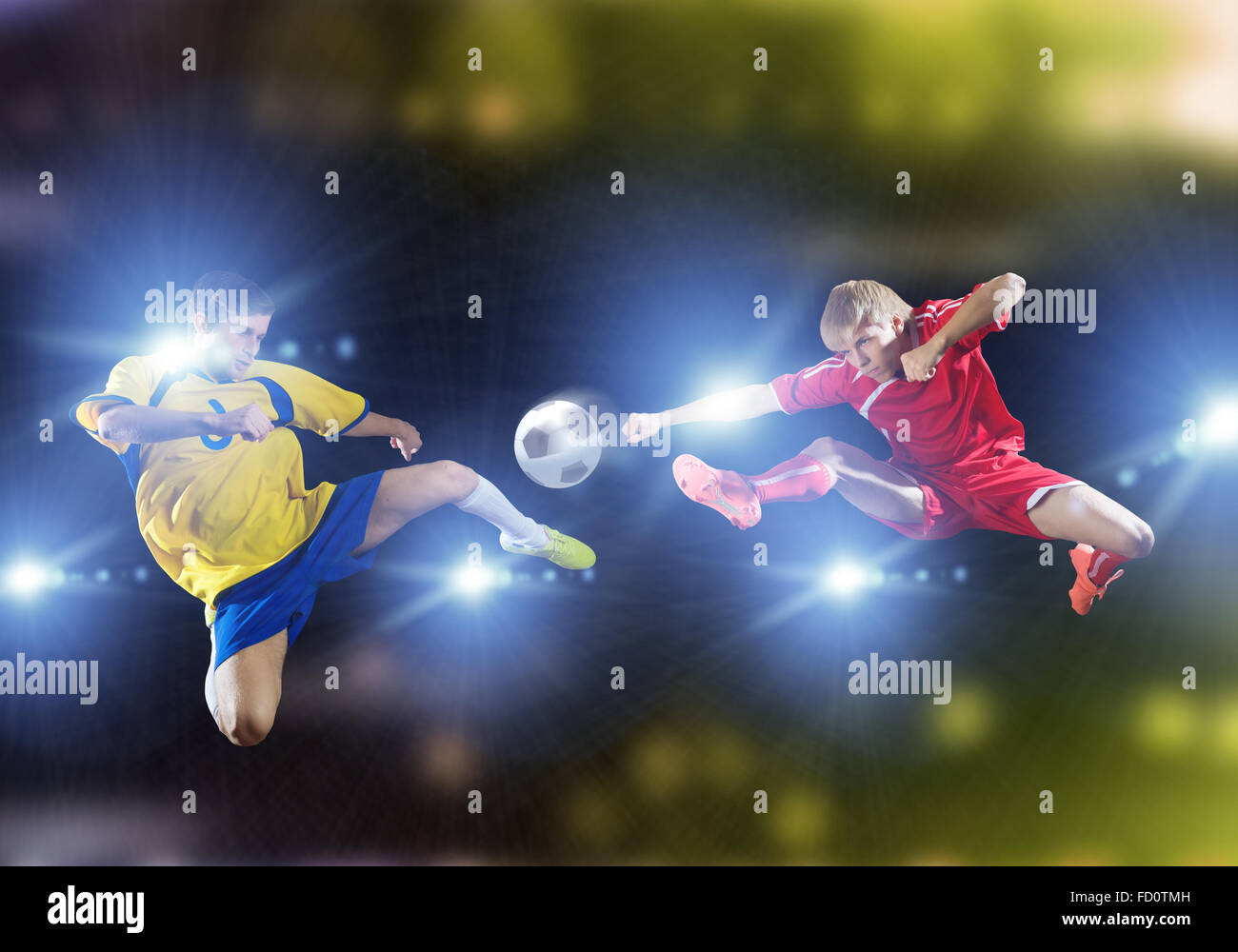 Two young football players struggling for ball Stock Photo - Alamy
