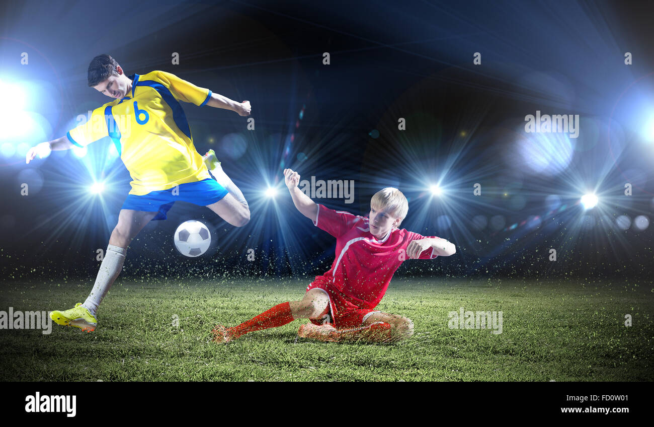 Two young football players struggling for ball Stock Photo - Alamy
