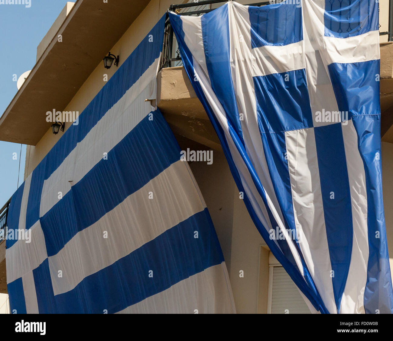 Greek flags hanging from balcony Stock Photo - Alamy