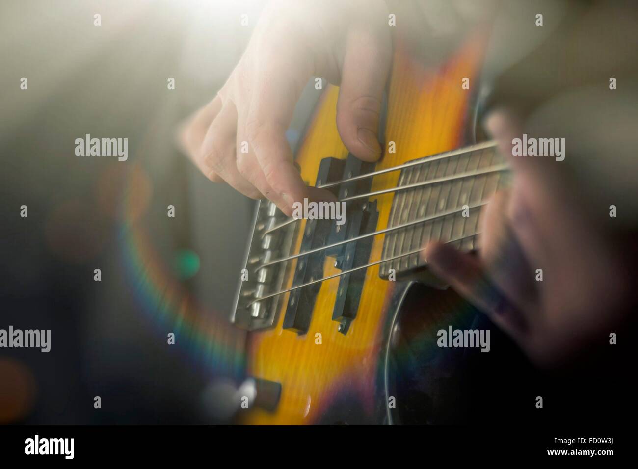 Closeup male musician playing electric bass guitar Stock Photo - Alamy