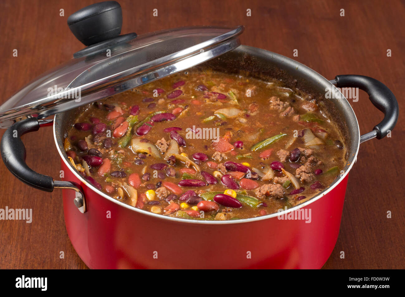 Hot and spicy Chili con carne in a large red pot Stock Photo - Alamy