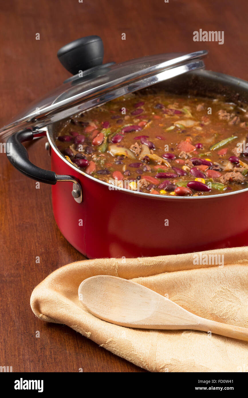 Hot and spicy Chili con carne in a large red pot Stock Photo - Alamy