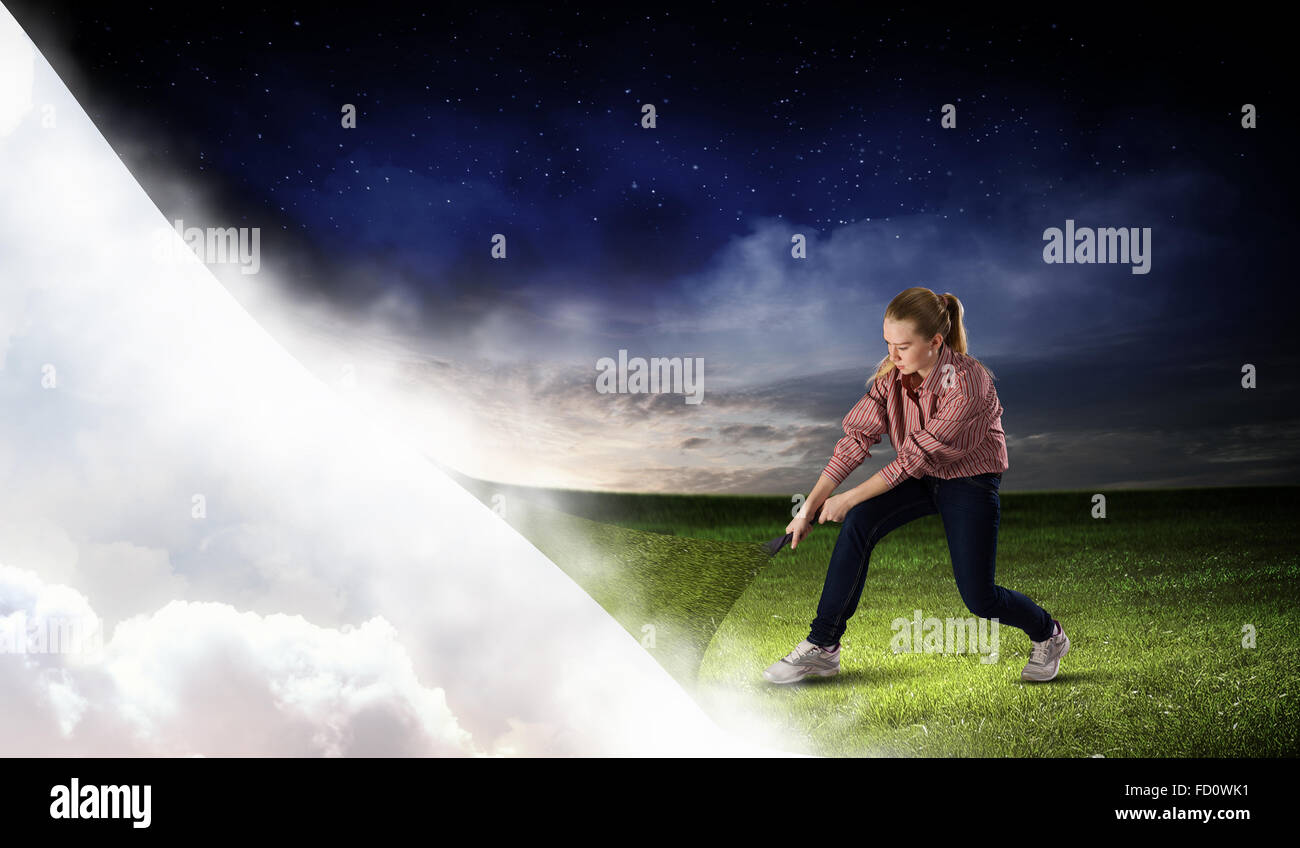 Young woman in casual turning page of reality Stock Photo - Alamy