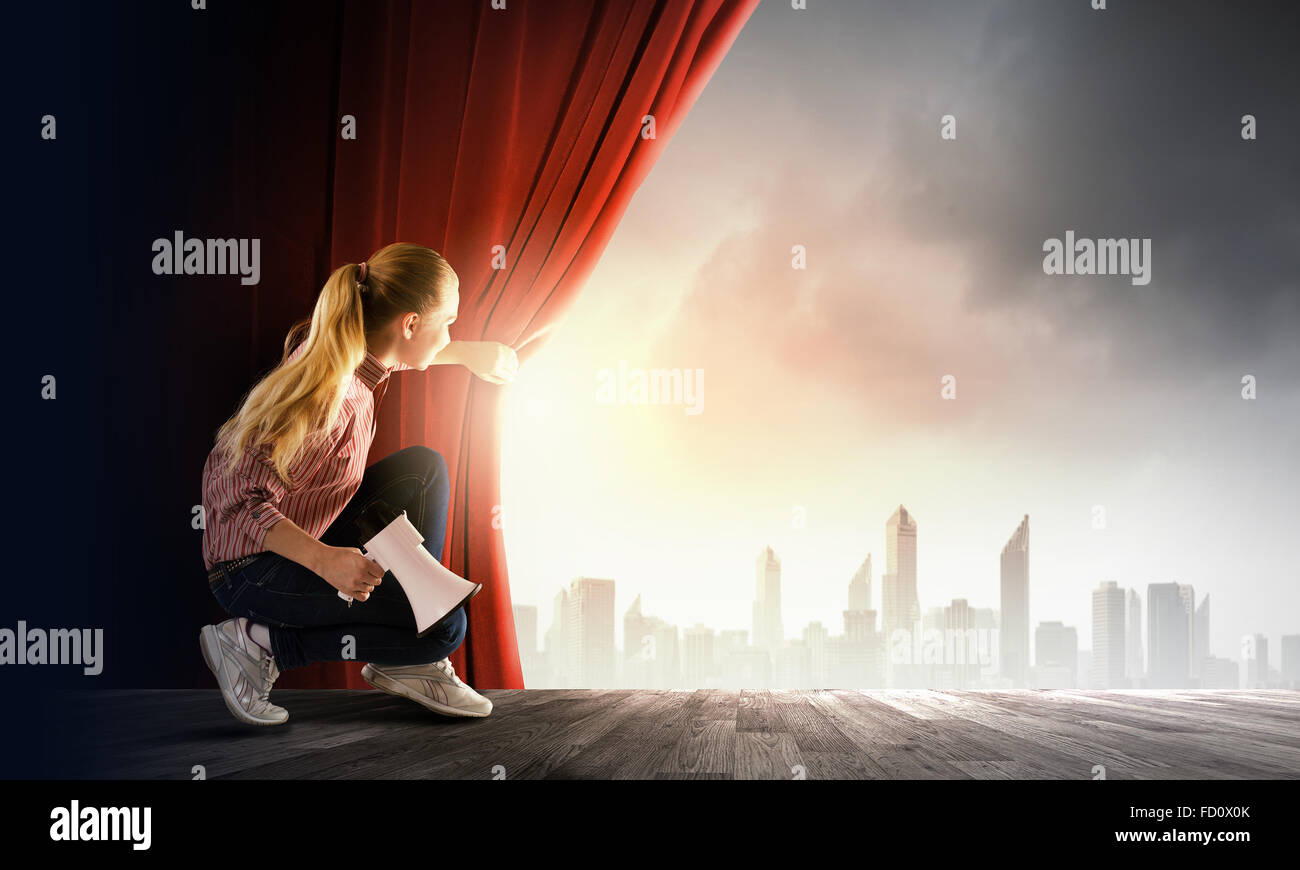 Young girl on stage with megaphone opening red curtain Stock Photo - Alamy