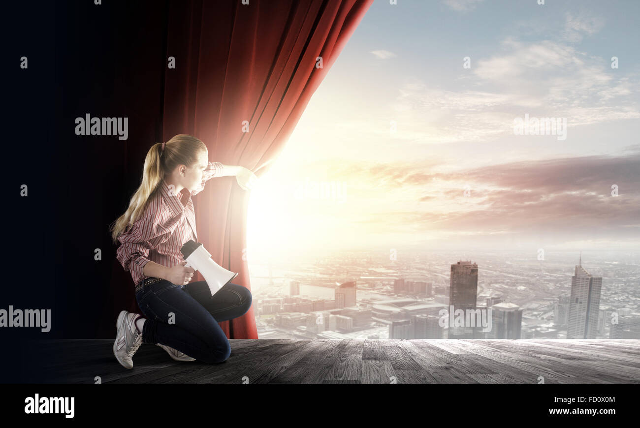 Young girl on stage with megaphone opening red curtain Stock Photo - Alamy