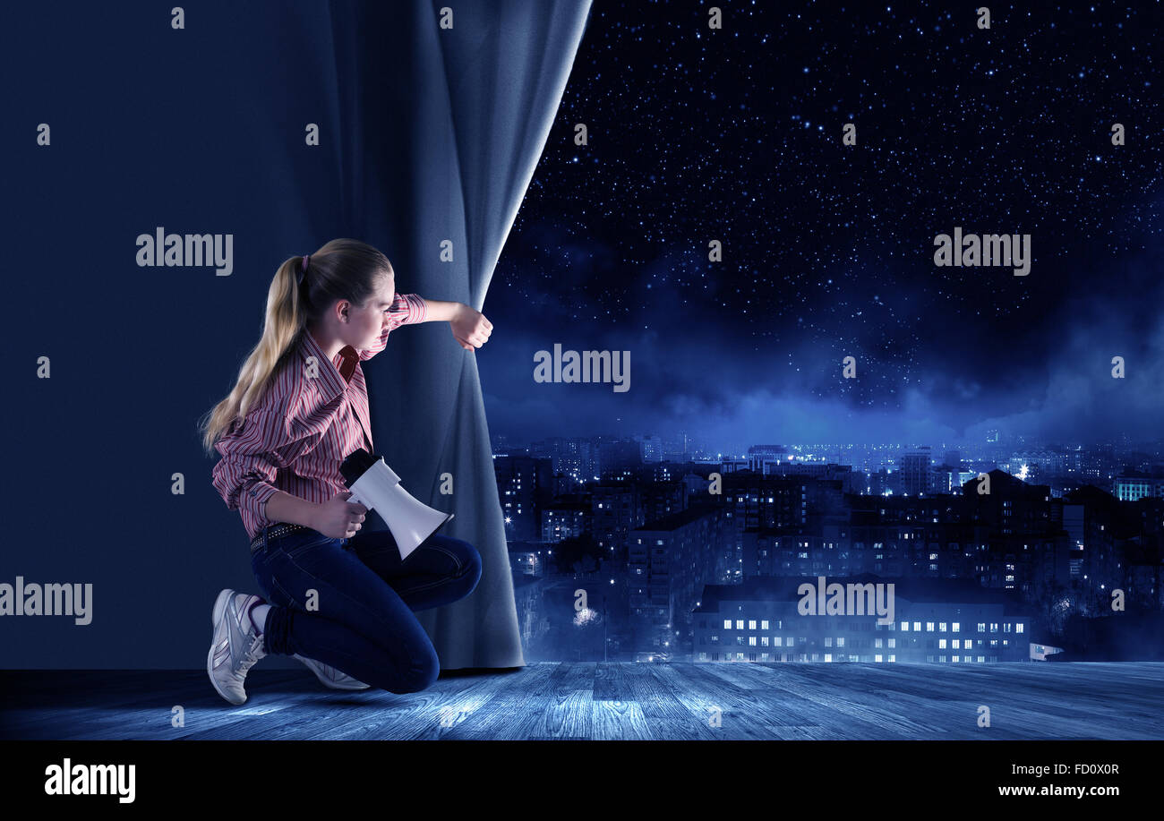 Young girl on stage with megaphone opening blue curtain Stock Photo - Alamy
