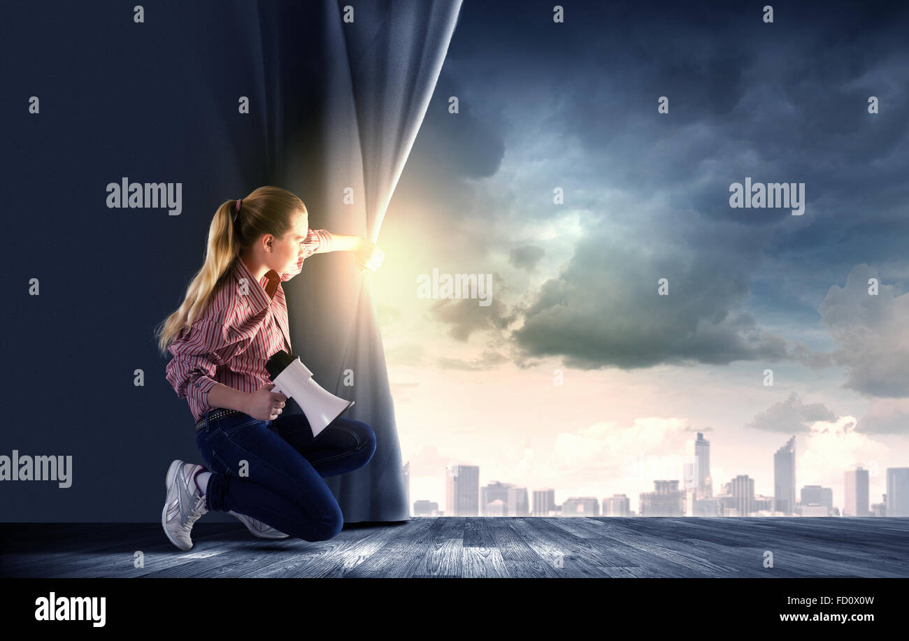 Young girl on stage with megaphone opening blue curtain Stock Photo - Alamy