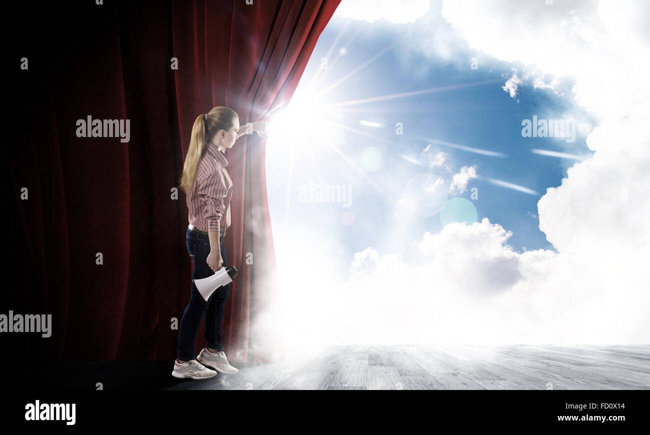 Young girl on stage with megaphone opening red curtain Stock Photo - Alamy