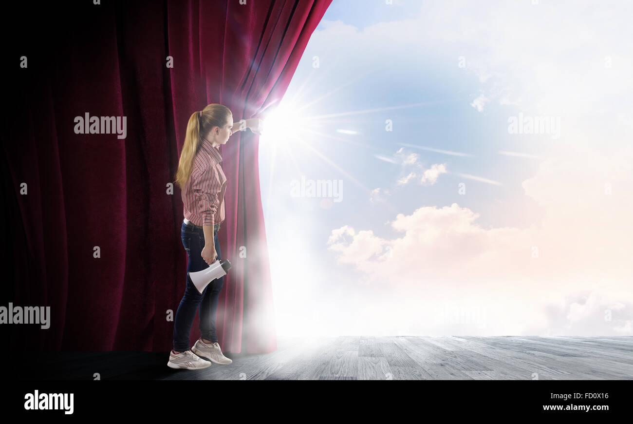 Young girl on stage with megaphone opening red curtain Stock Photo - Alamy
