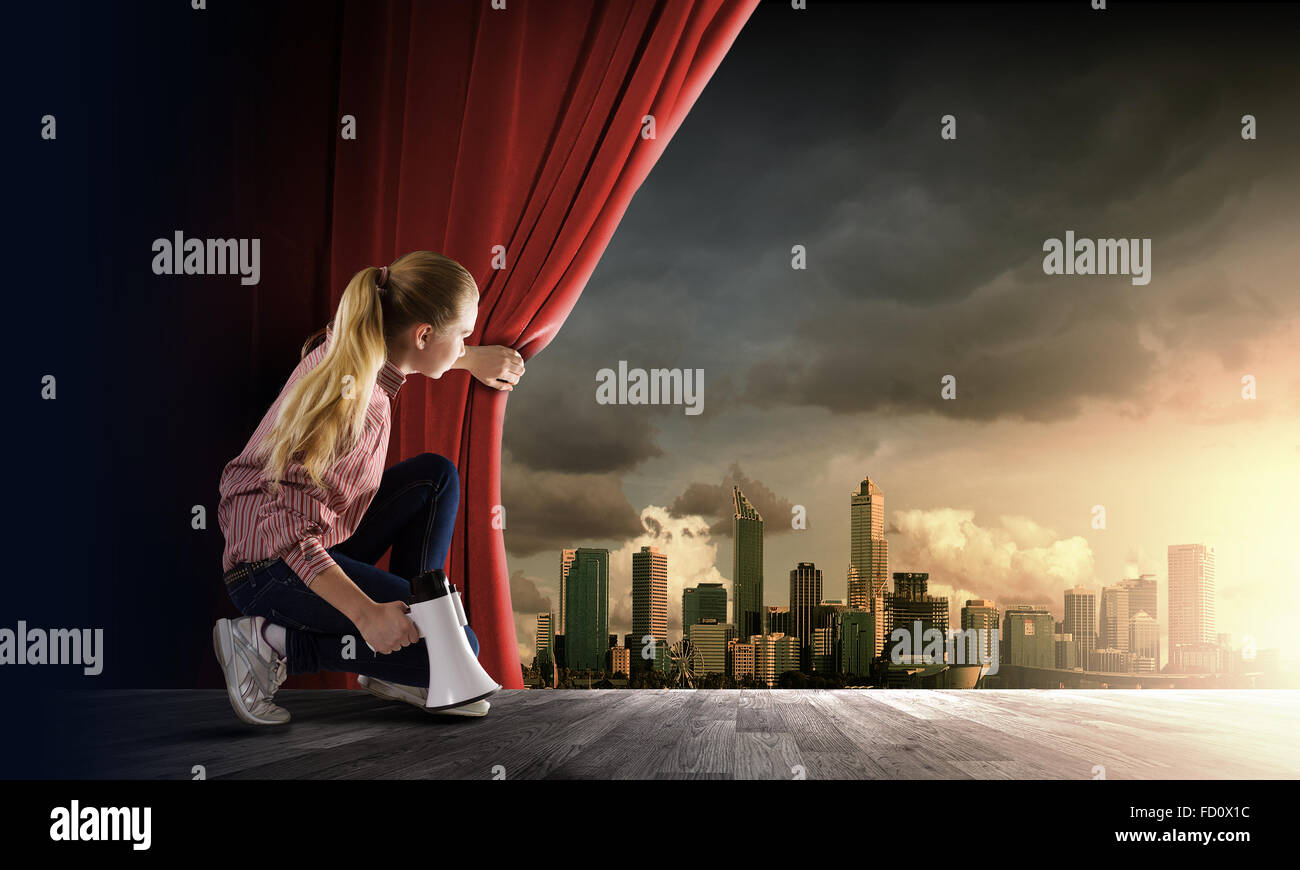 Young girl on stage with megaphone opening red curtain Stock Photo - Alamy