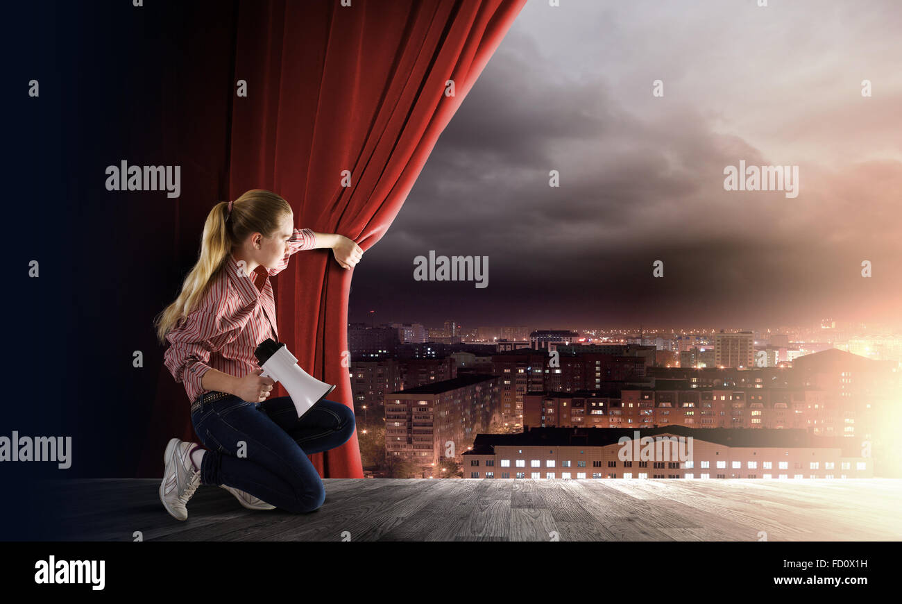 Young girl on stage with megaphone opening red curtain Stock Photo - Alamy