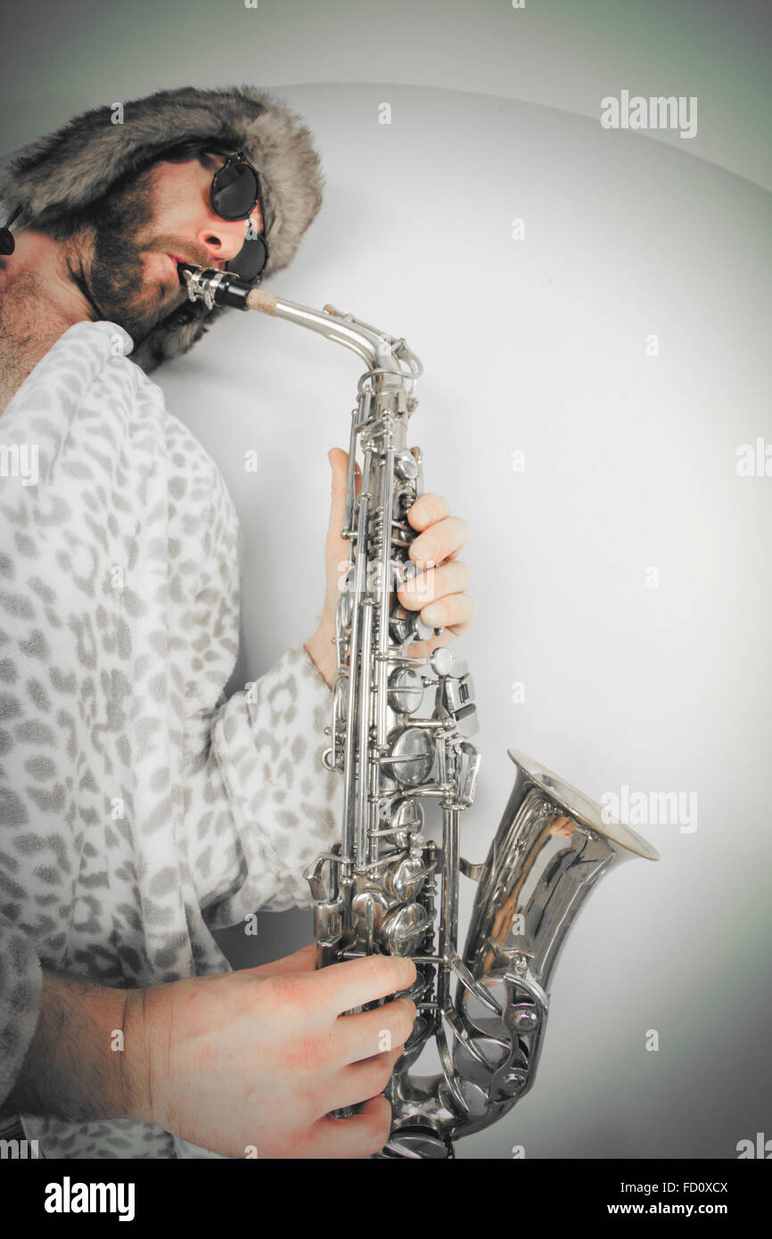 Bearded hipster plays jazz saxophone in leopard print bathrobe taken ...