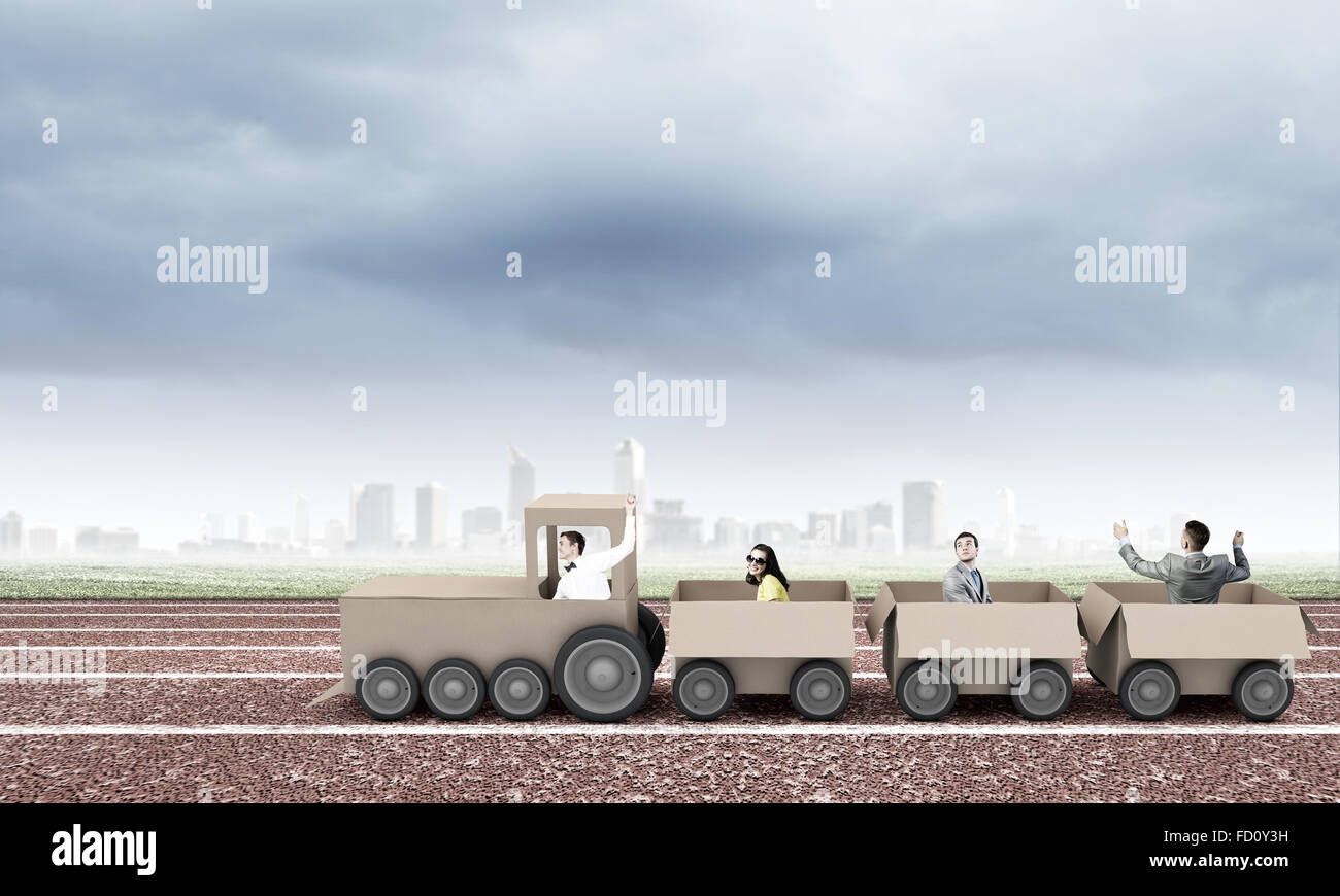 Business people riding carton train. Teamwork concept Stock Photo - Alamy
