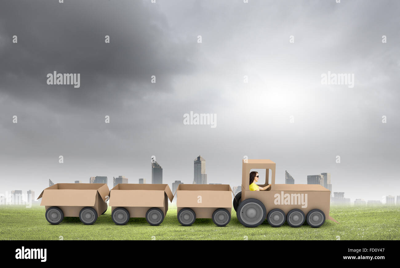 Young woman riding carton train. Women in business Stock Photo - Alamy