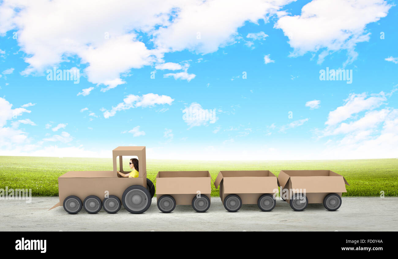 Young woman riding carton train. Women in business Stock Photo - Alamy