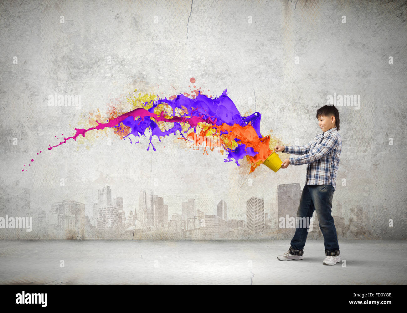 Young boy splashing colorful paint from bucket Stock Photo - Alamy