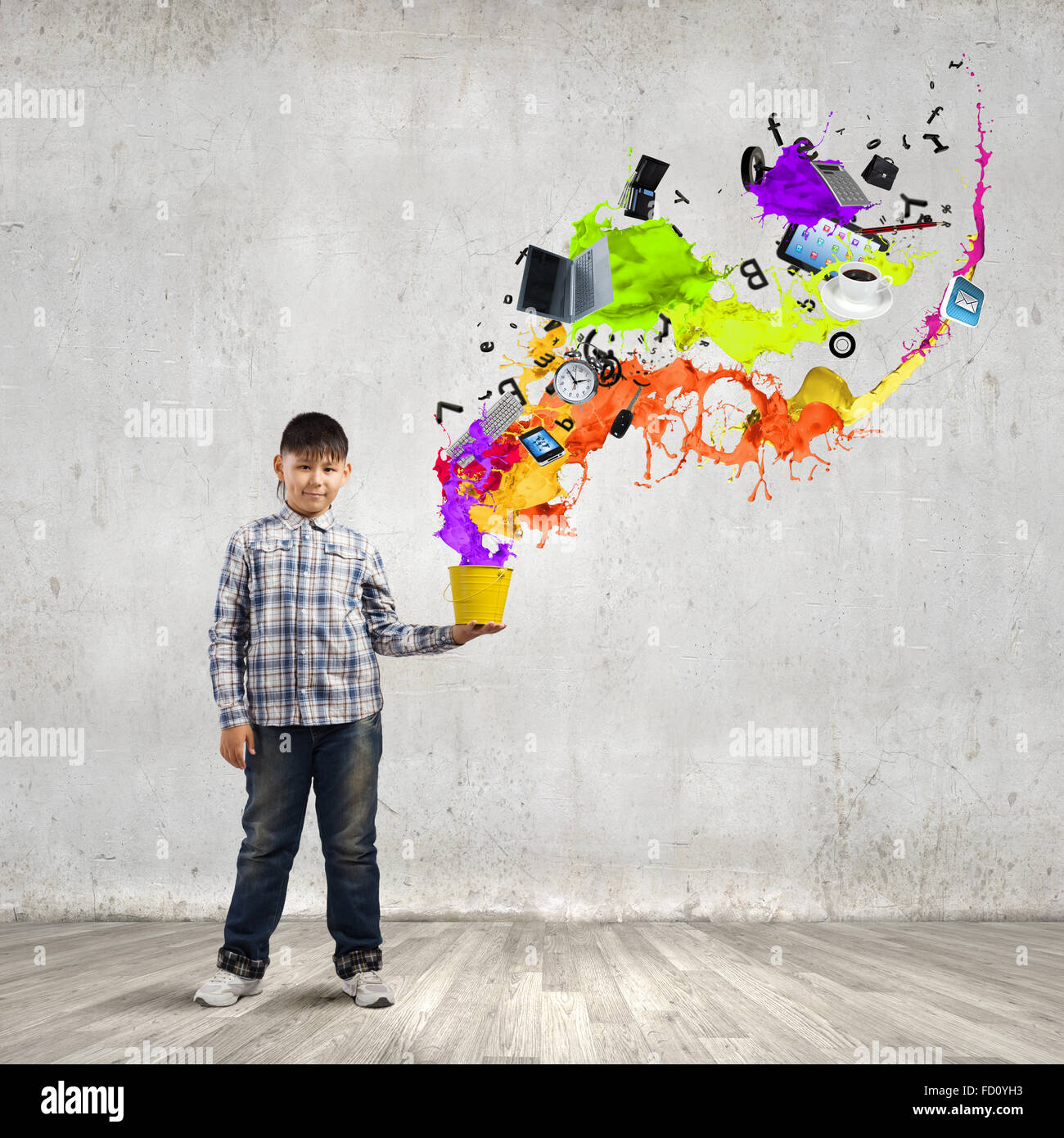 Young boy splashing colorful paint from bucket Stock Photo - Alamy