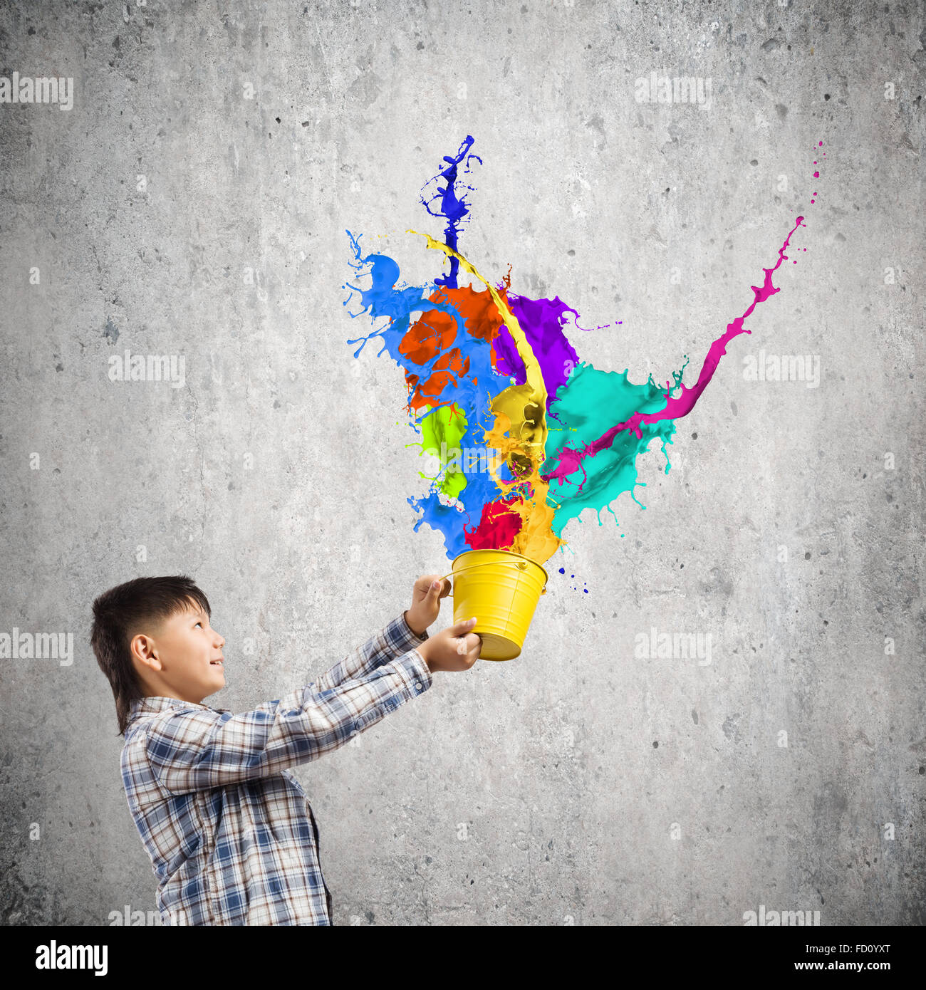 Young boy splashing colorful paint from bucket Stock Photo - Alamy