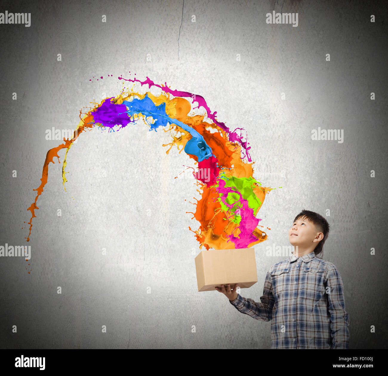 Young boy splashing colorful paint from carton box Stock Photo - Alamy