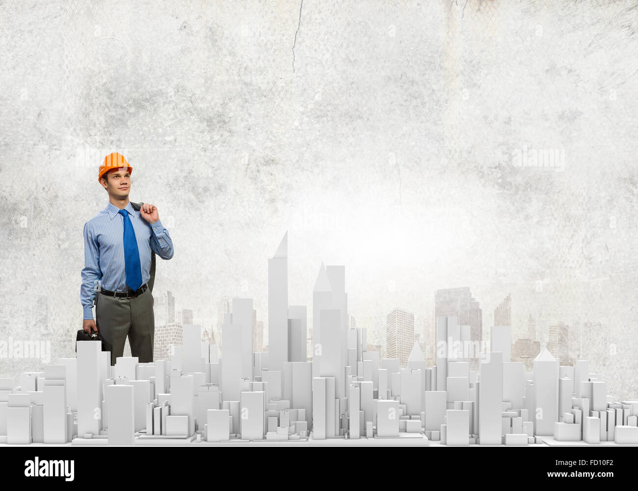 Young businessman examining model of construction project Stock Photo ...